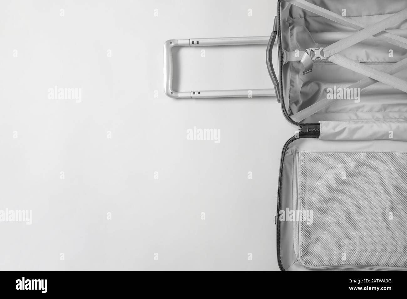 Open empty suitcase on light grey background, top view. Space for text Stock Photo - Alamy