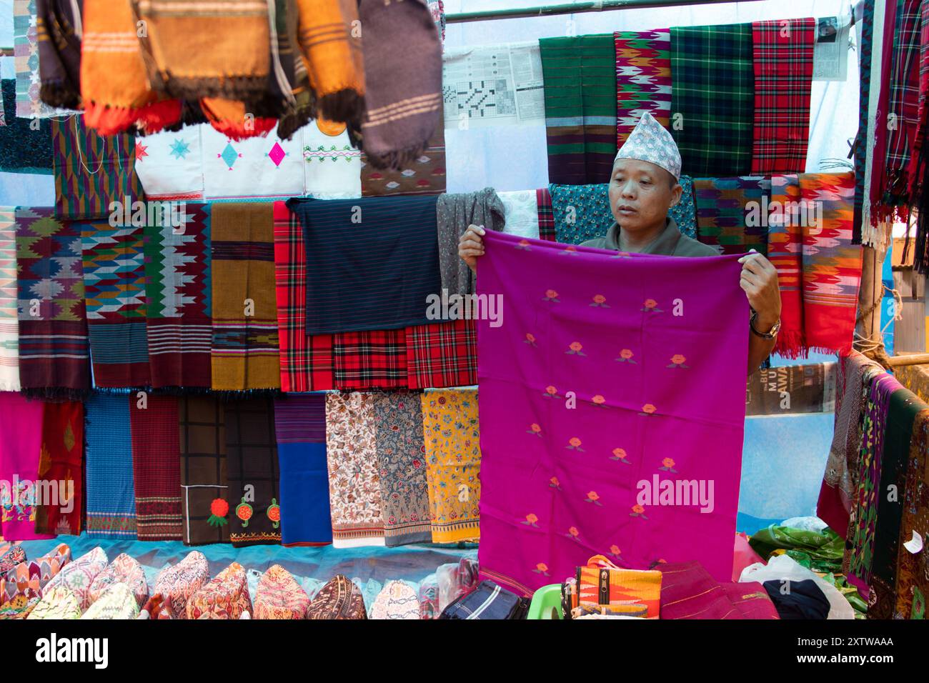 A Haat Bazaar vendor sells various handwoven textiles native to Eastern ...