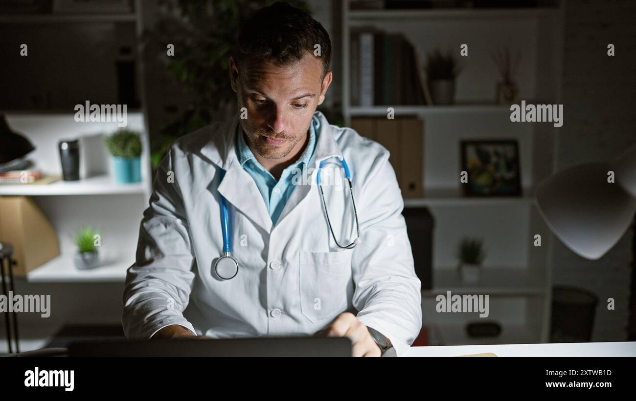 Young hispanic male doctor working late in the office, reflecting ...