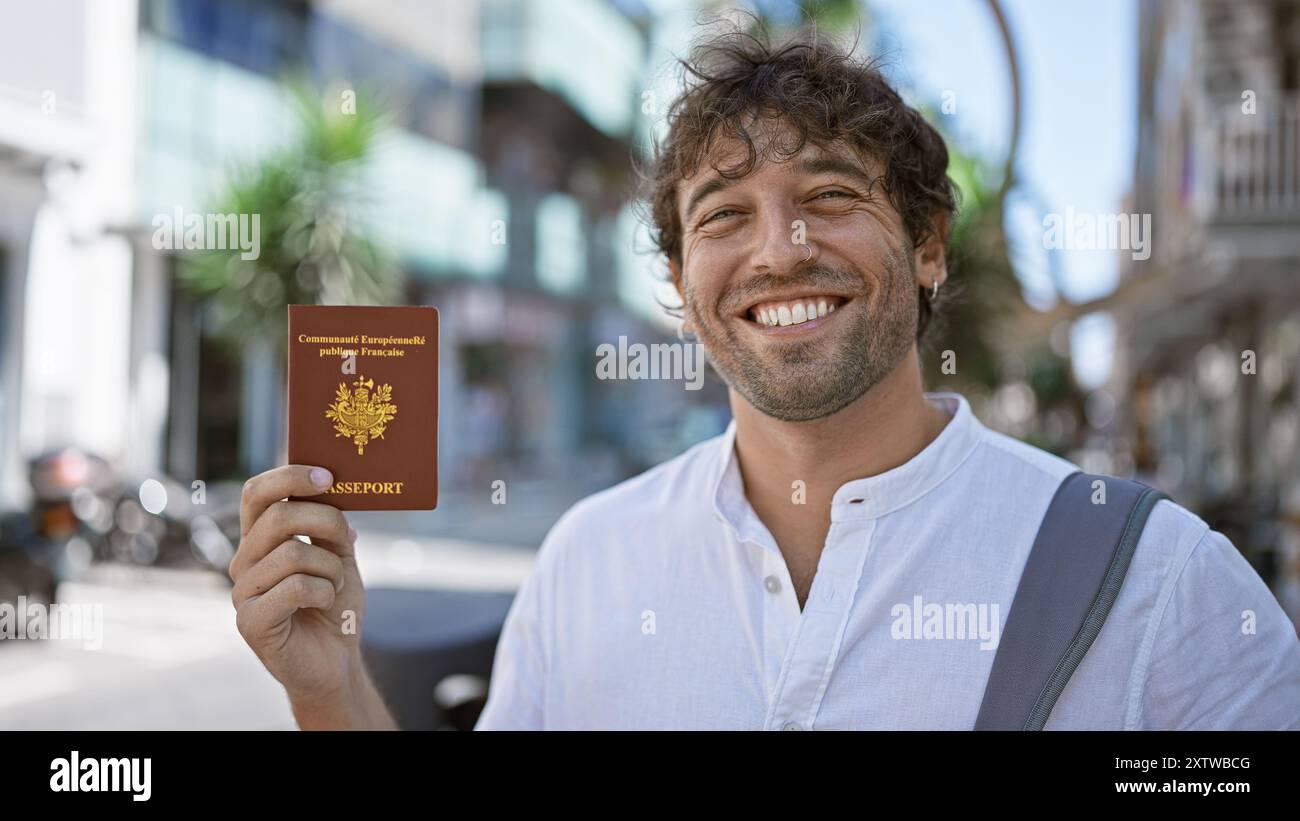 Smiling bearded man holding french passport on an urban street Stock ...