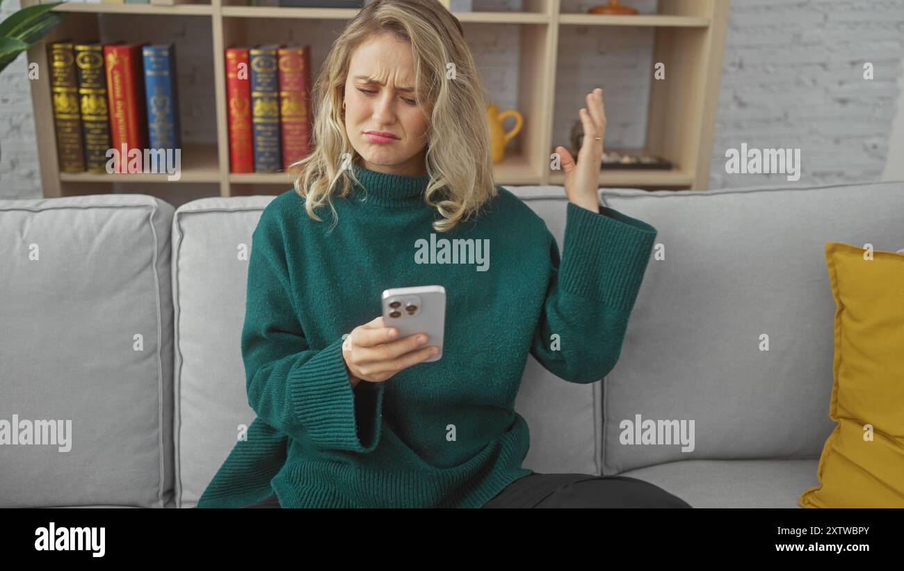 A perplexed young woman with blonde hair using her smartphone on a cozy ...