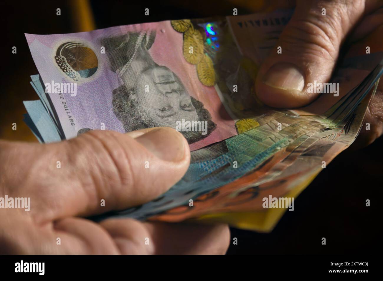 Hand holding cash notes Australian Dollars 5 10 20 50 Stock Photo - Alamy