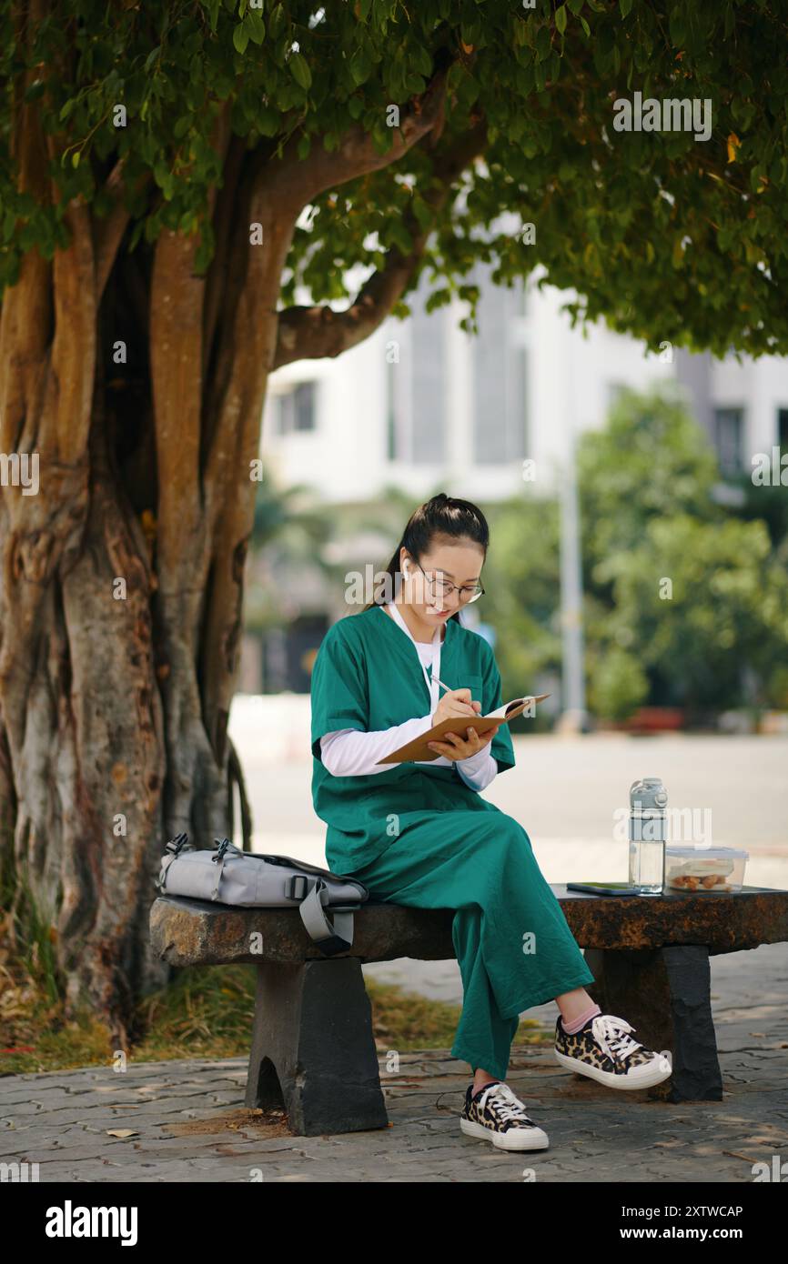 Medical Student Studying Under Tree in Park Area Stock Photo - Alamy