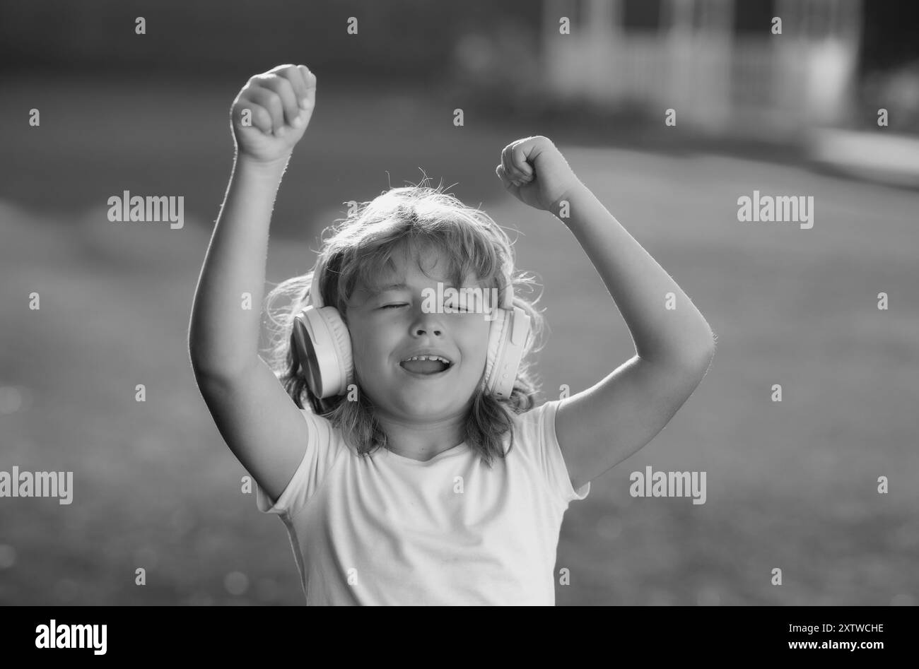 Singing and dancing children. Child with headphones listening to music ...