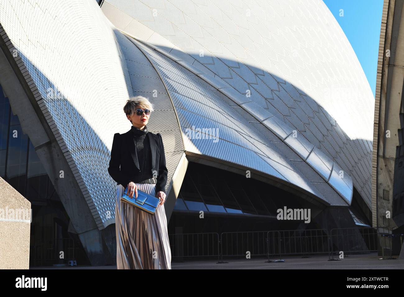 Sydney, Australia, a fashionable well dressed woman stands before the ...