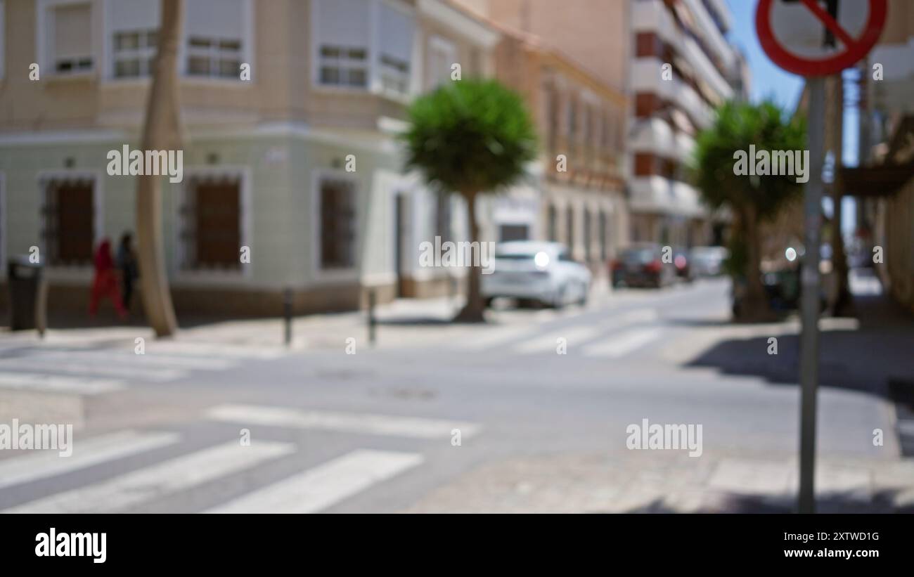 Blurred view of an outdoor urban street intersection with two women in ...