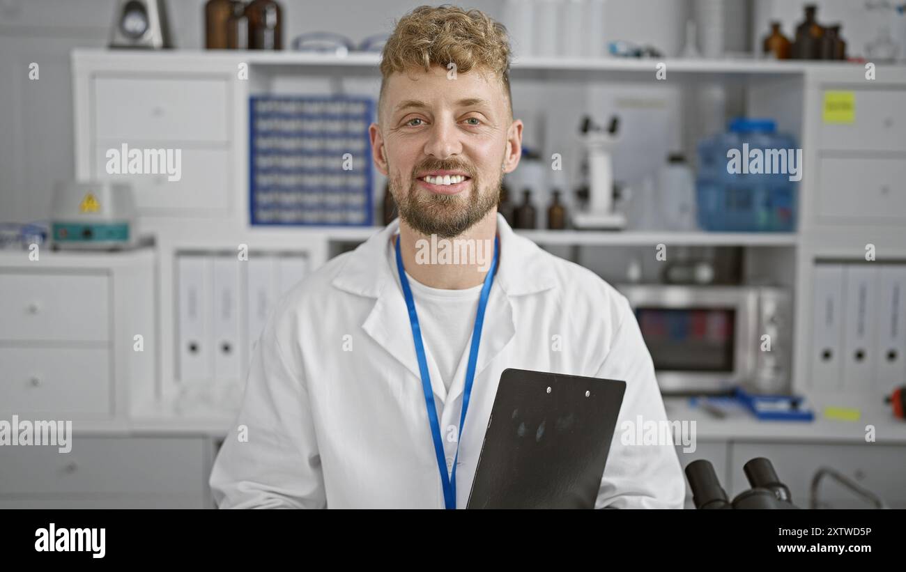 A handsome young man with blue eyes and a beard, wearing a lab coat and ...