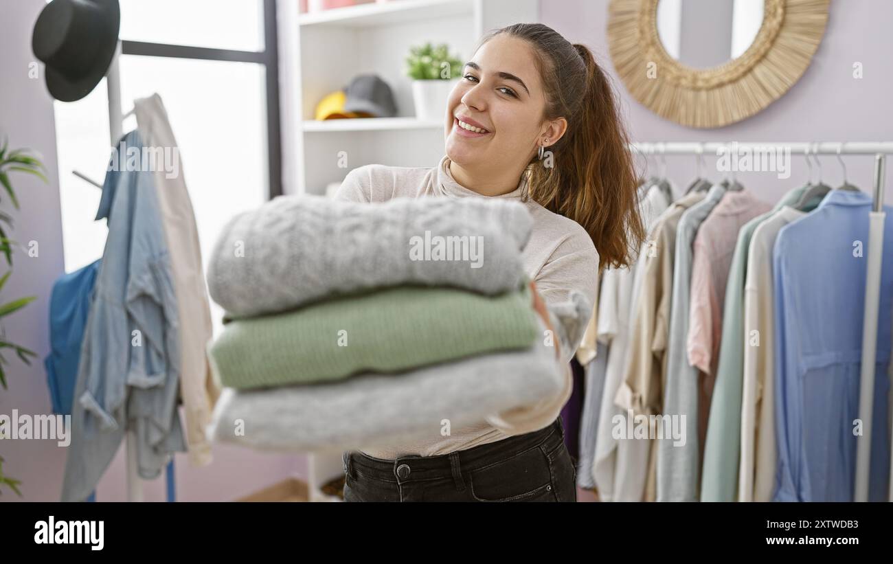 Young smiling woman sorting clothes hi-res stock photography and images ...
