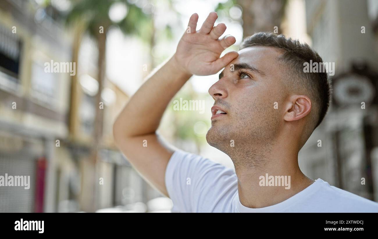 Young hispanic man shades eyes hi-res stock photography and images - Alamy