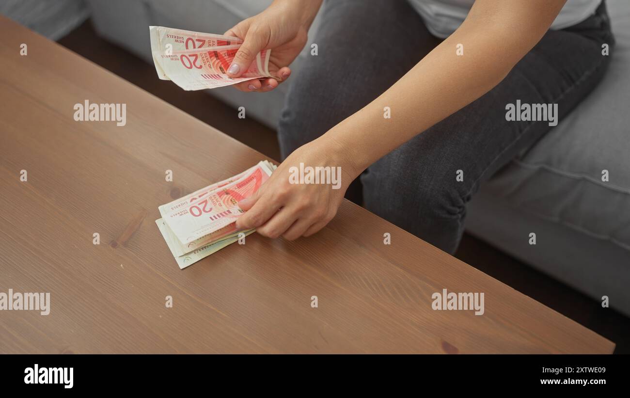 A woman counts shekels, the currency of israel, inside a modern home ...