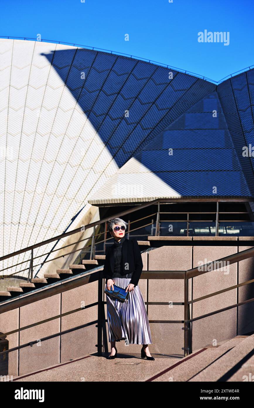 Sydney, Australia, a stylish woman enjoys a visit to the Sydney Opera ...