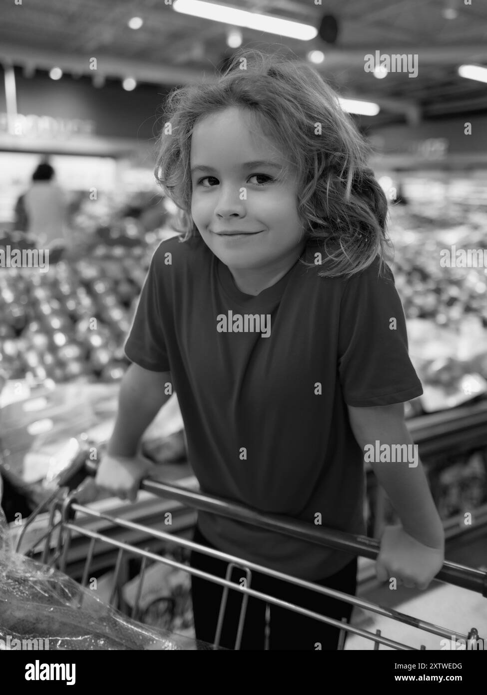 Kid with shopping cart at grocery store. Kid at vegetable supermarket ...
