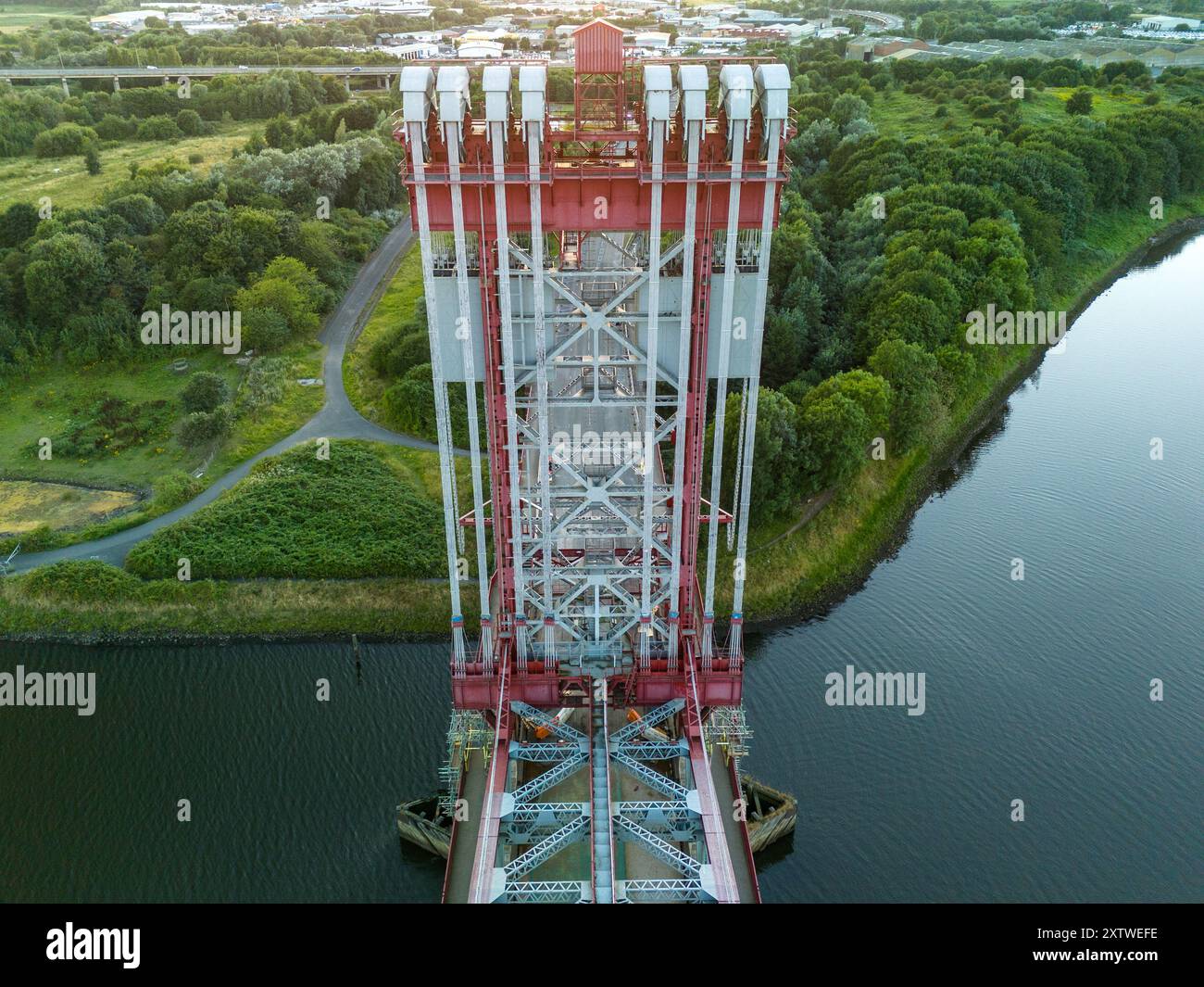 Aerial view of a red drawbridge tower standing tall over a river ...