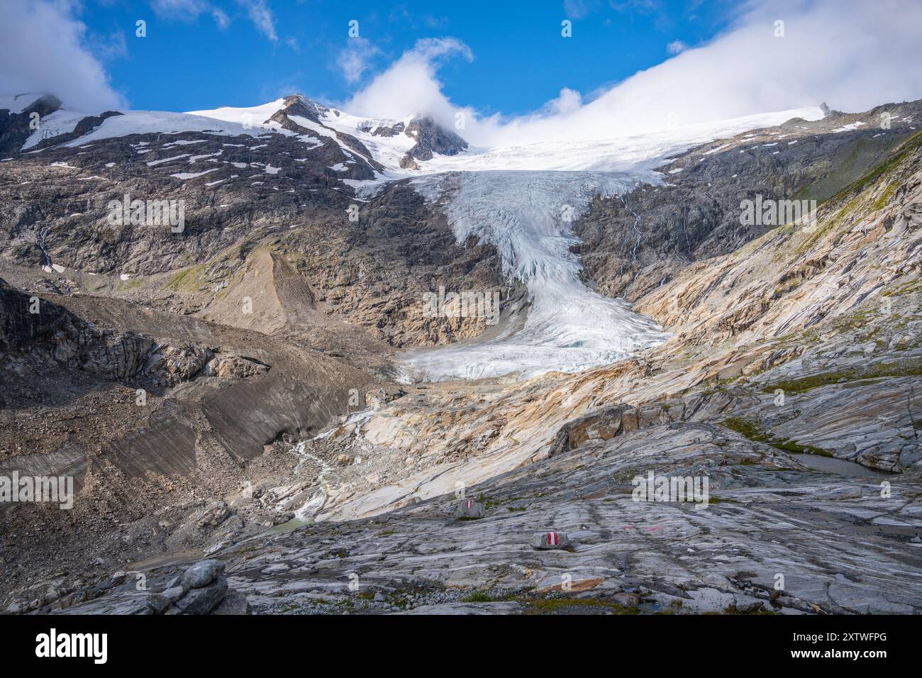 The Schlaten Glacier cascades down a rugged landscape, surrounded by ...