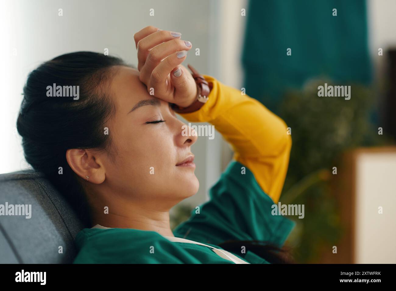 Relaxing on Couch Resting Hand on Forehead with Eyes Closed Stock Photo ...