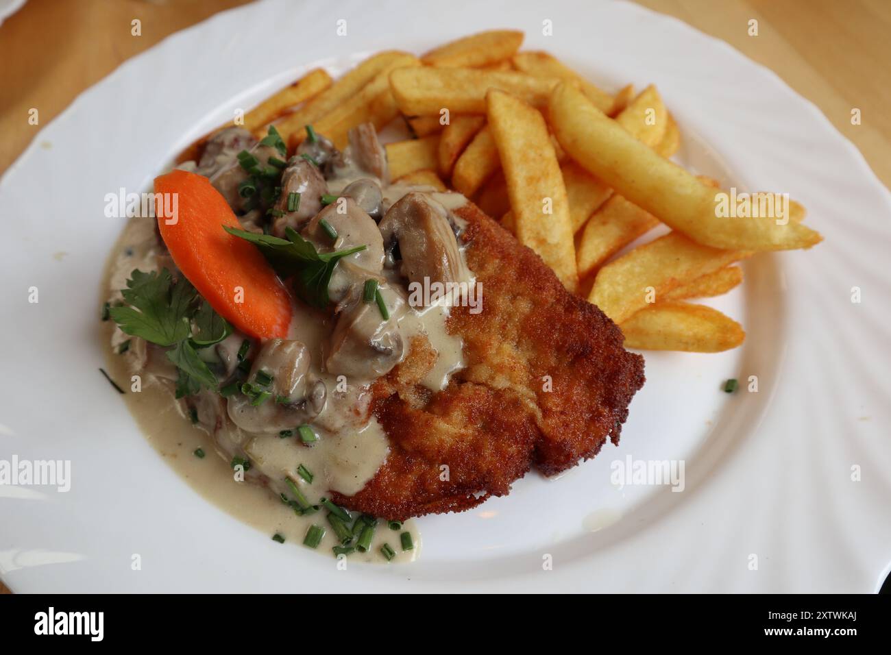 German cuisine: wiener schnitzel (cutlet) with mushroom sauce in ...