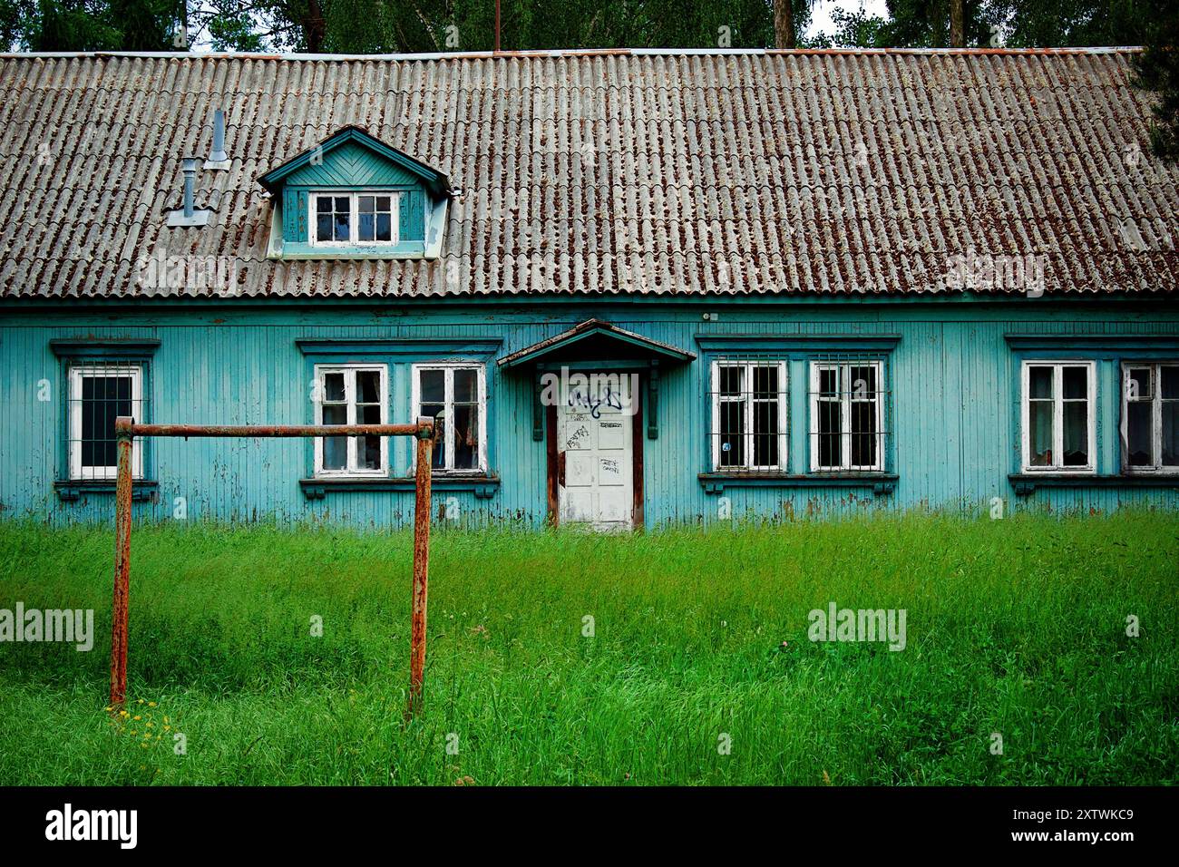 Abandoned Rustic House with Overgrown Grass and Rusted Swing Set in ...