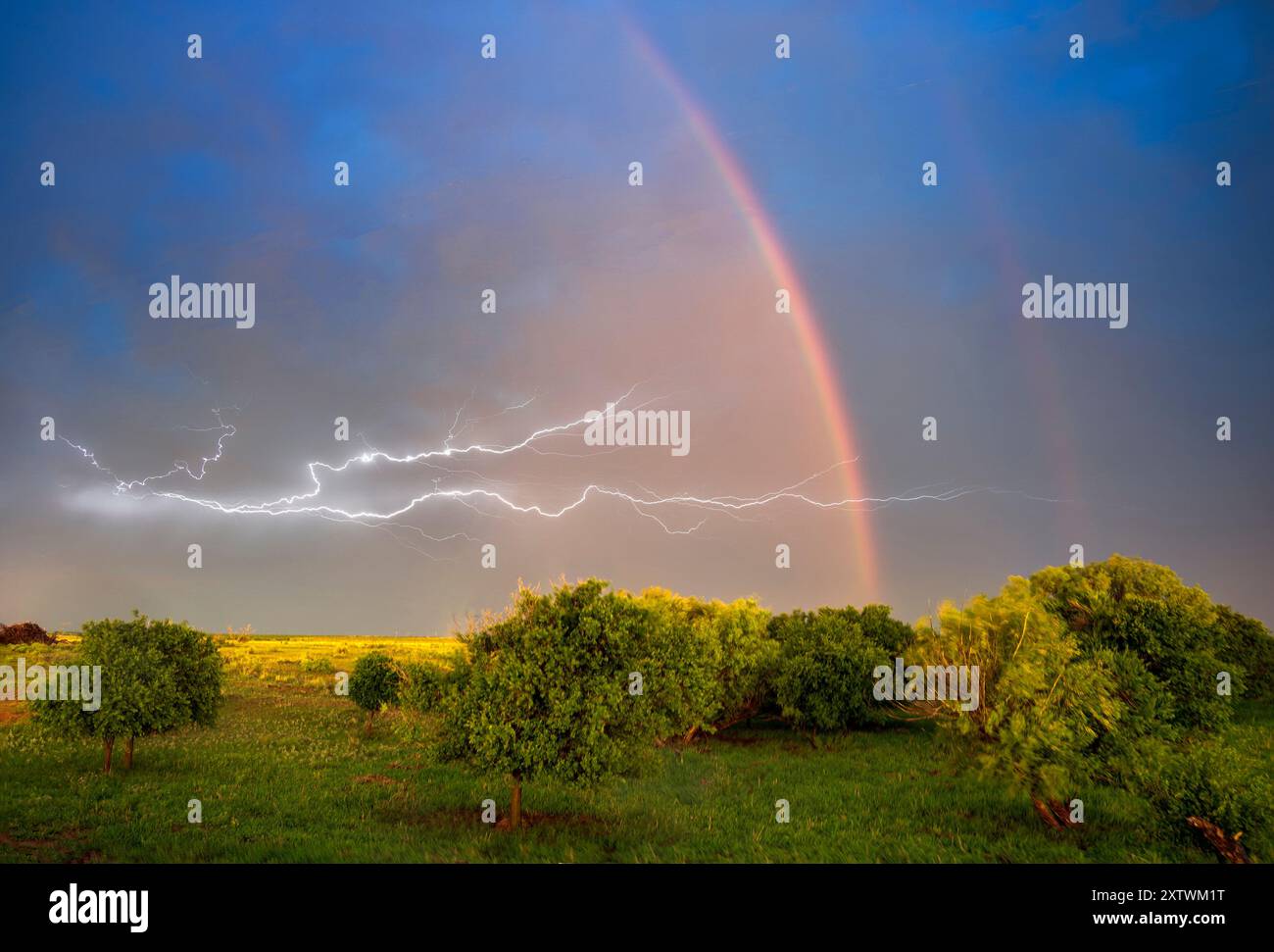 Dramatic double rainbow arcs above hi-res stock photography and images ...