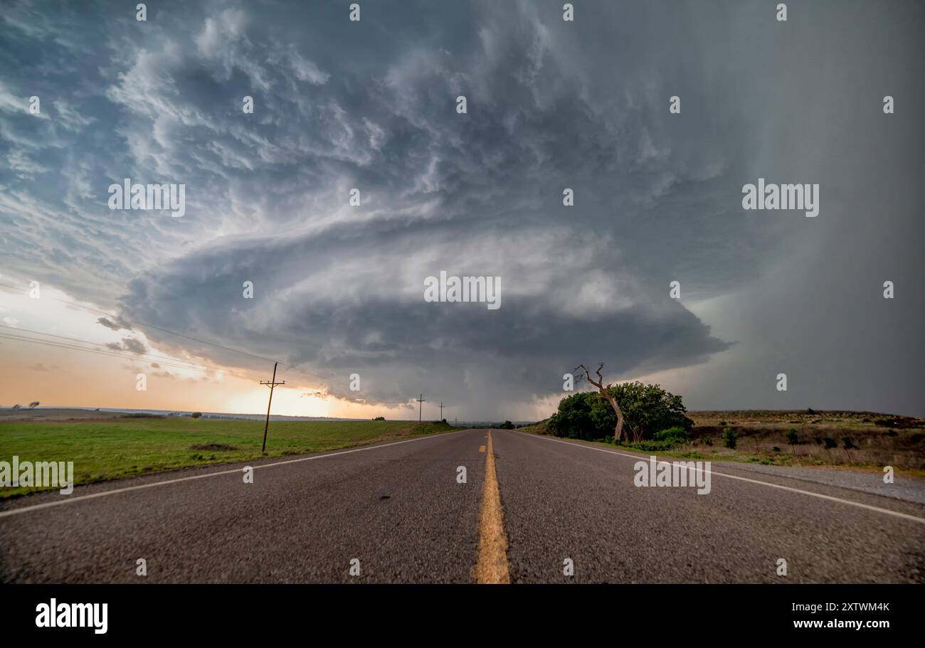 Dramatic supercell storm with a swirling cloud formation looms over an ... Dramatic supercell storm with a swirling cloud formation looms over an ...
