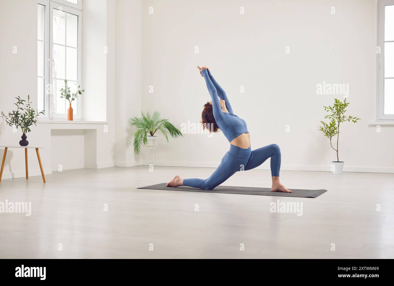 Yogi sporty woman practicing yoga, doing Horse rider exercise ...