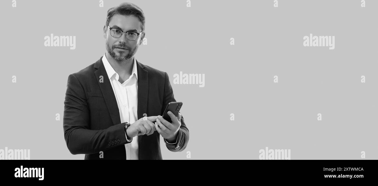 Man in suit using mobile phone isolated on studio background. Portrait ...
