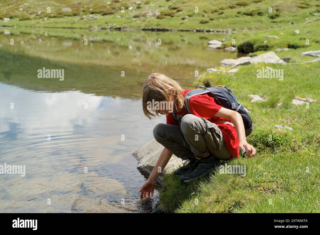 Child touching water hi-res stock photography and images - Alamy