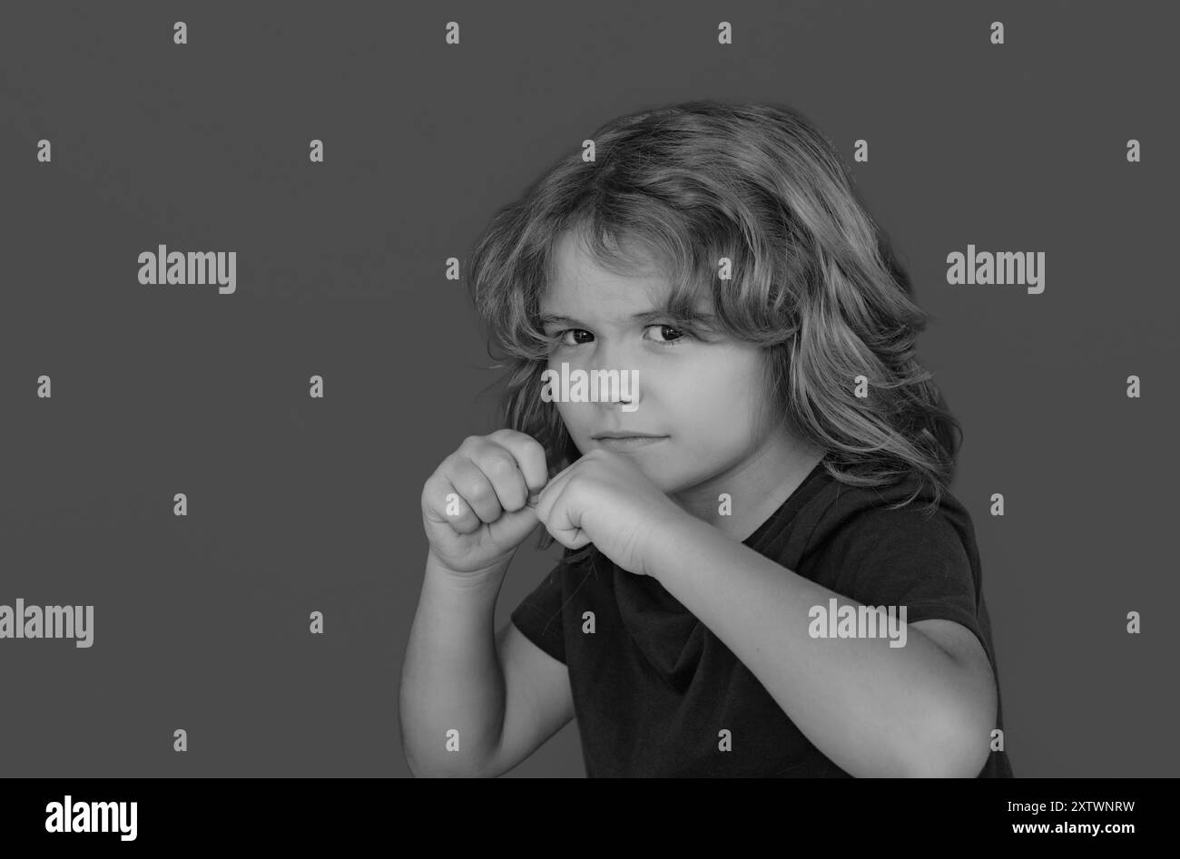 Angry child with fist gesture fight, hit on yellow studio isolated ...