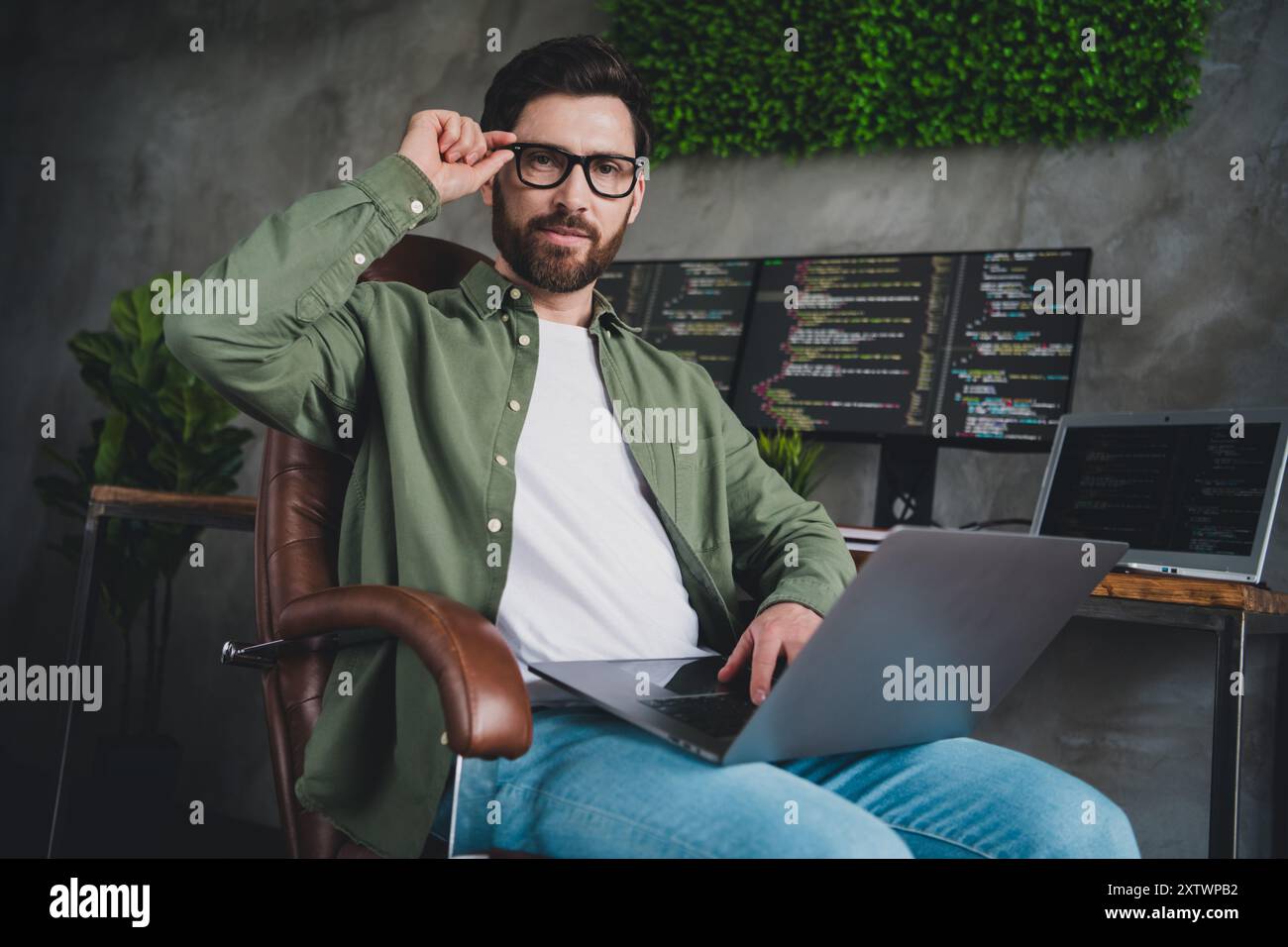 Portrait of professional hacker young man laptop computer desk loft ...