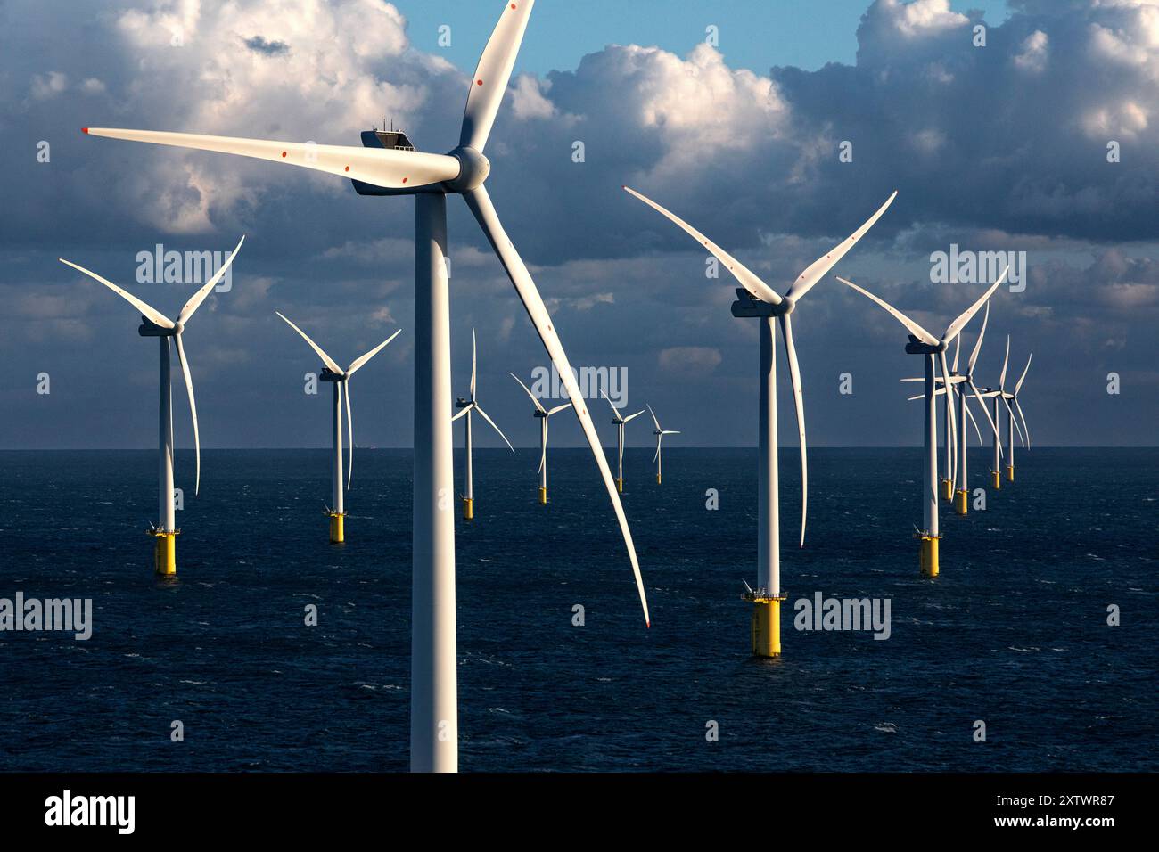 Wind turbines against sunset backdrop hi-res stock photography and ...
