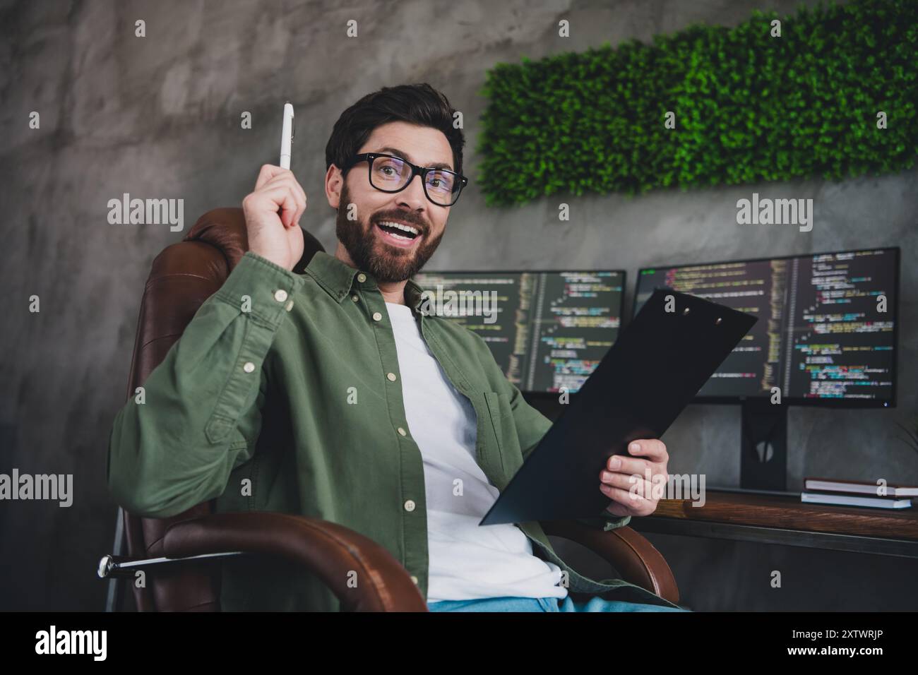 Portrait of professional hacker young man point pen clipboard computer ...