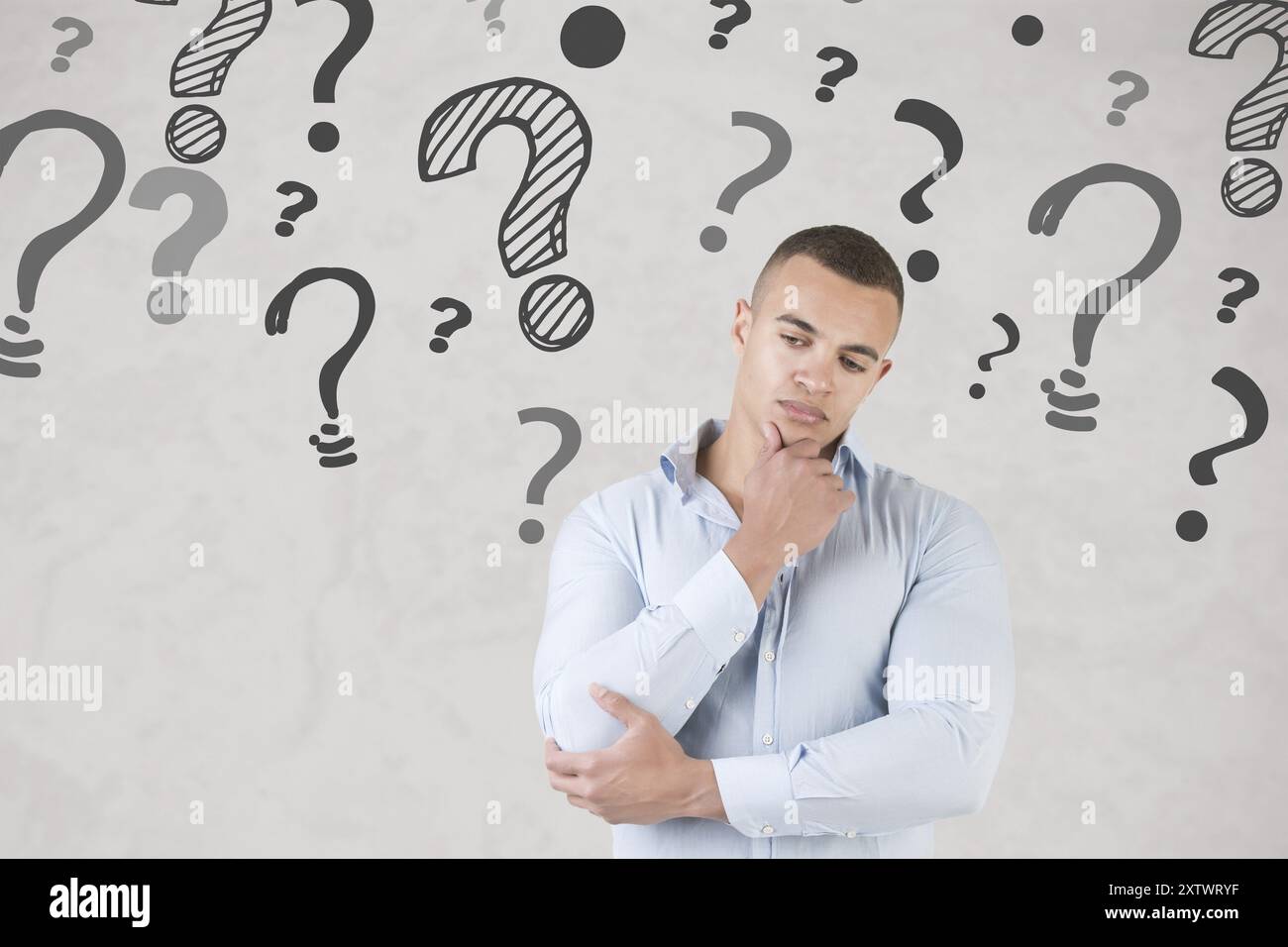 Man wondering with question marks around him Stock Photo - Alamy