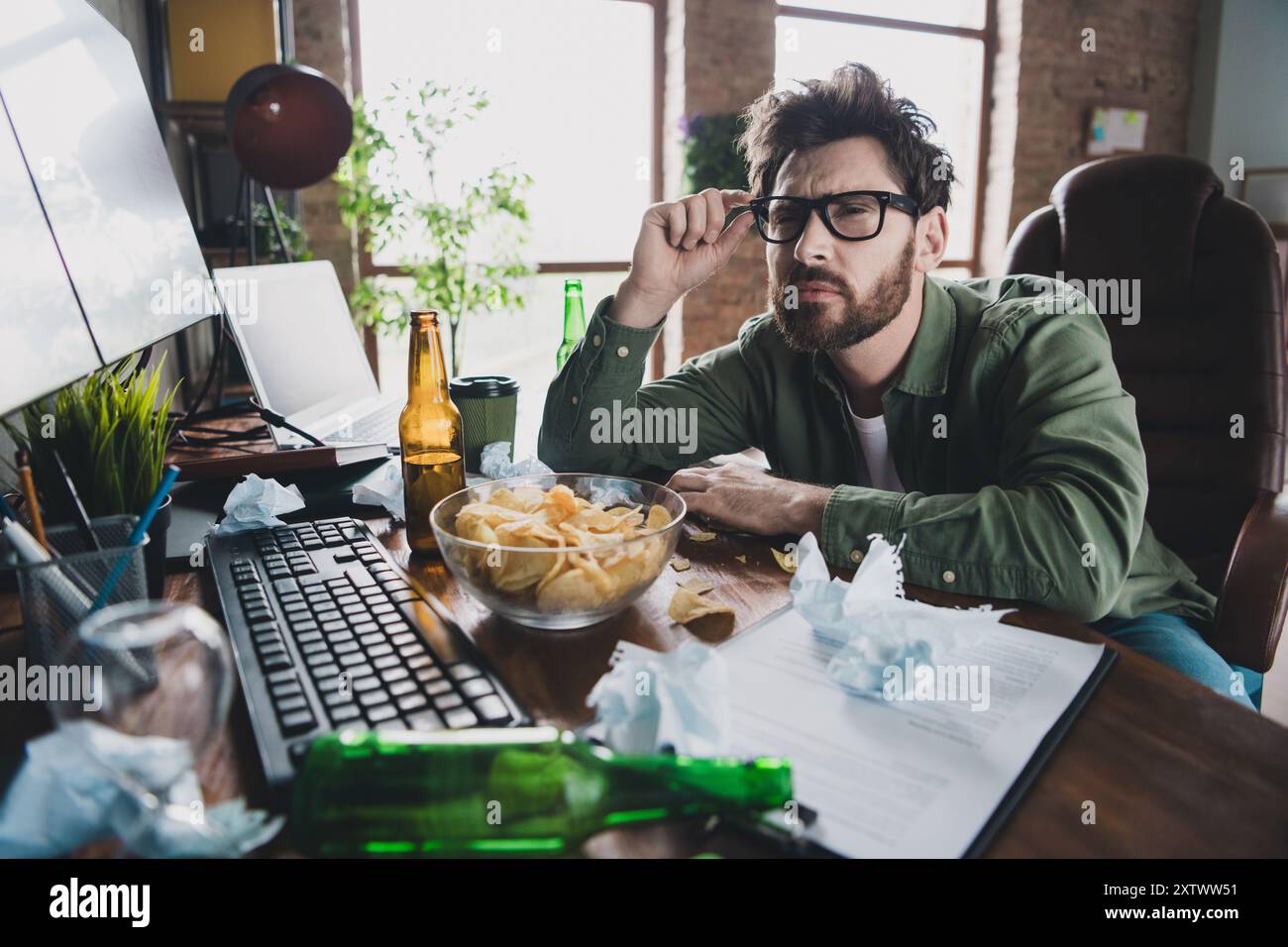 Portrait of drunk professional hacker young man computer desk loft ...