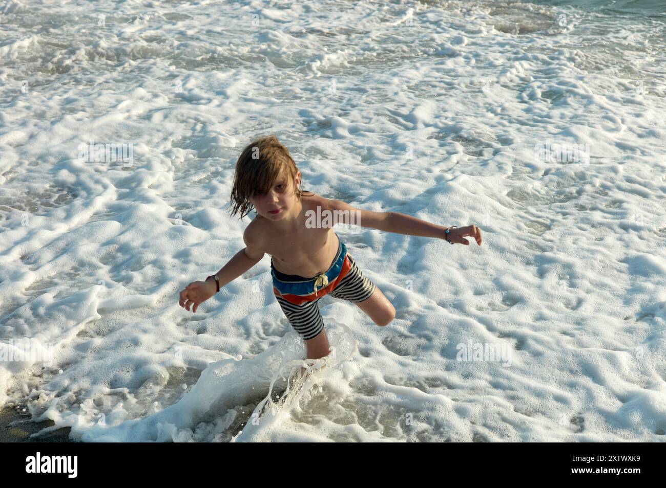 Boy playing in ocean hi-res stock photography and images - Alamy