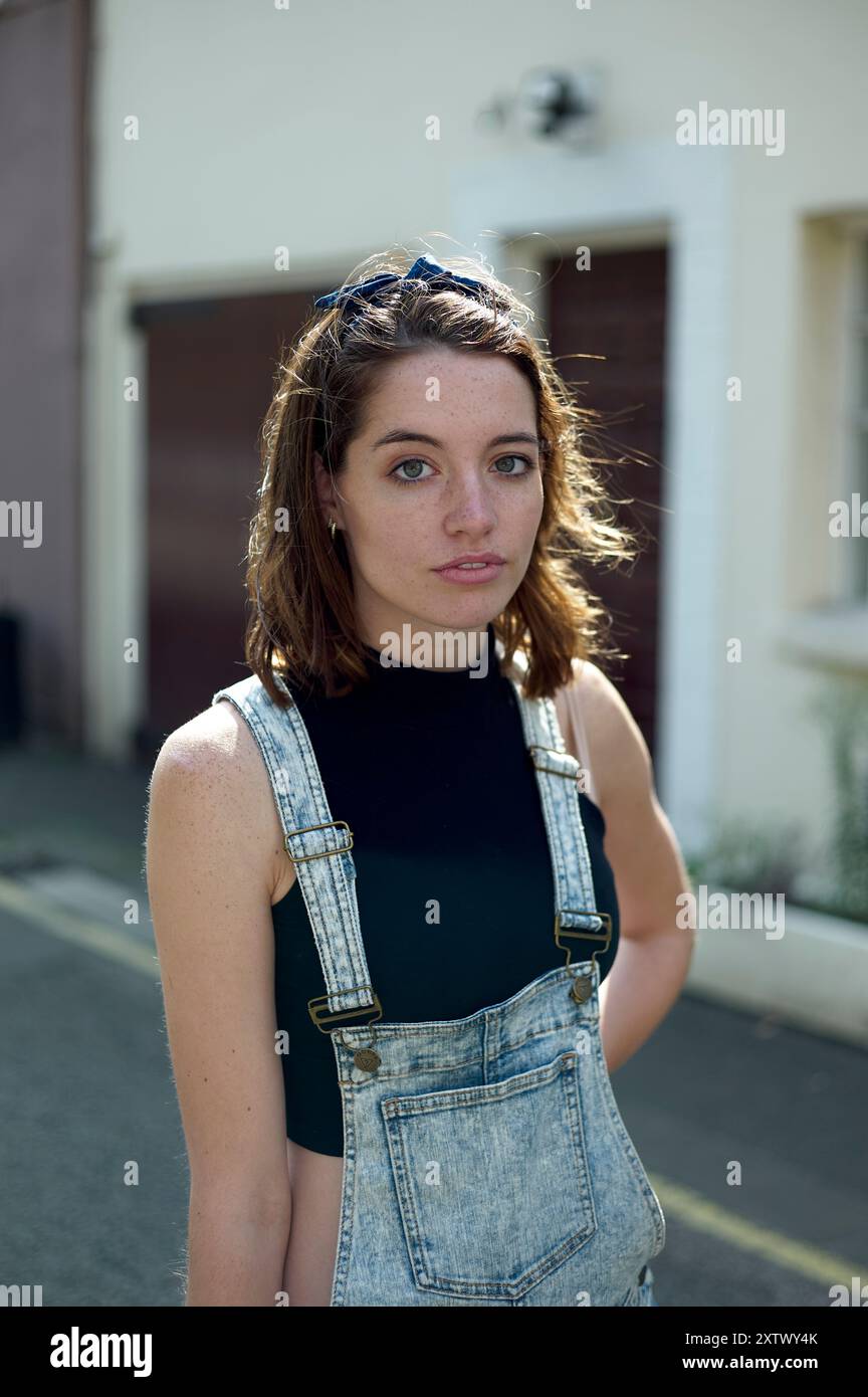 Urban woman in denim overalls hi-res stock photography and images - Alamy