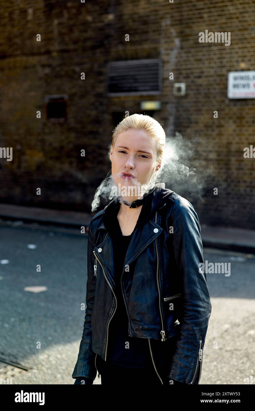Young woman exhaling smoke hi-res stock photography and images - Alamy