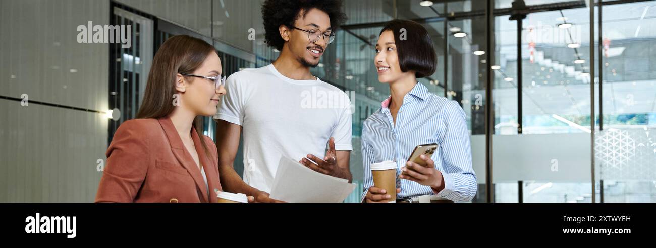 Three colleagues, chat and laugh in the lobby of a modern office Stock ...