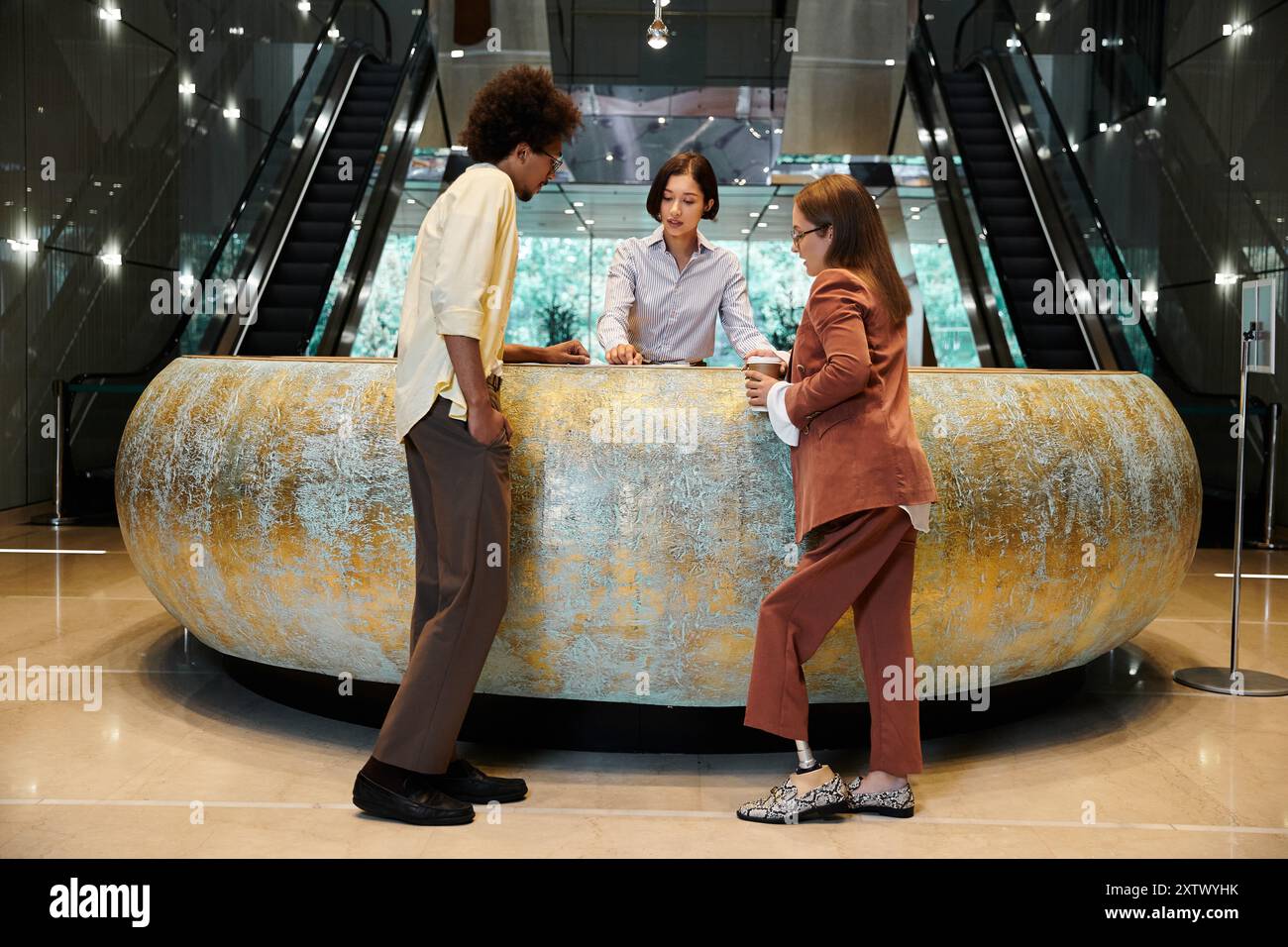 Three colleagues, including a woman with a prosthetic leg, chat and ...