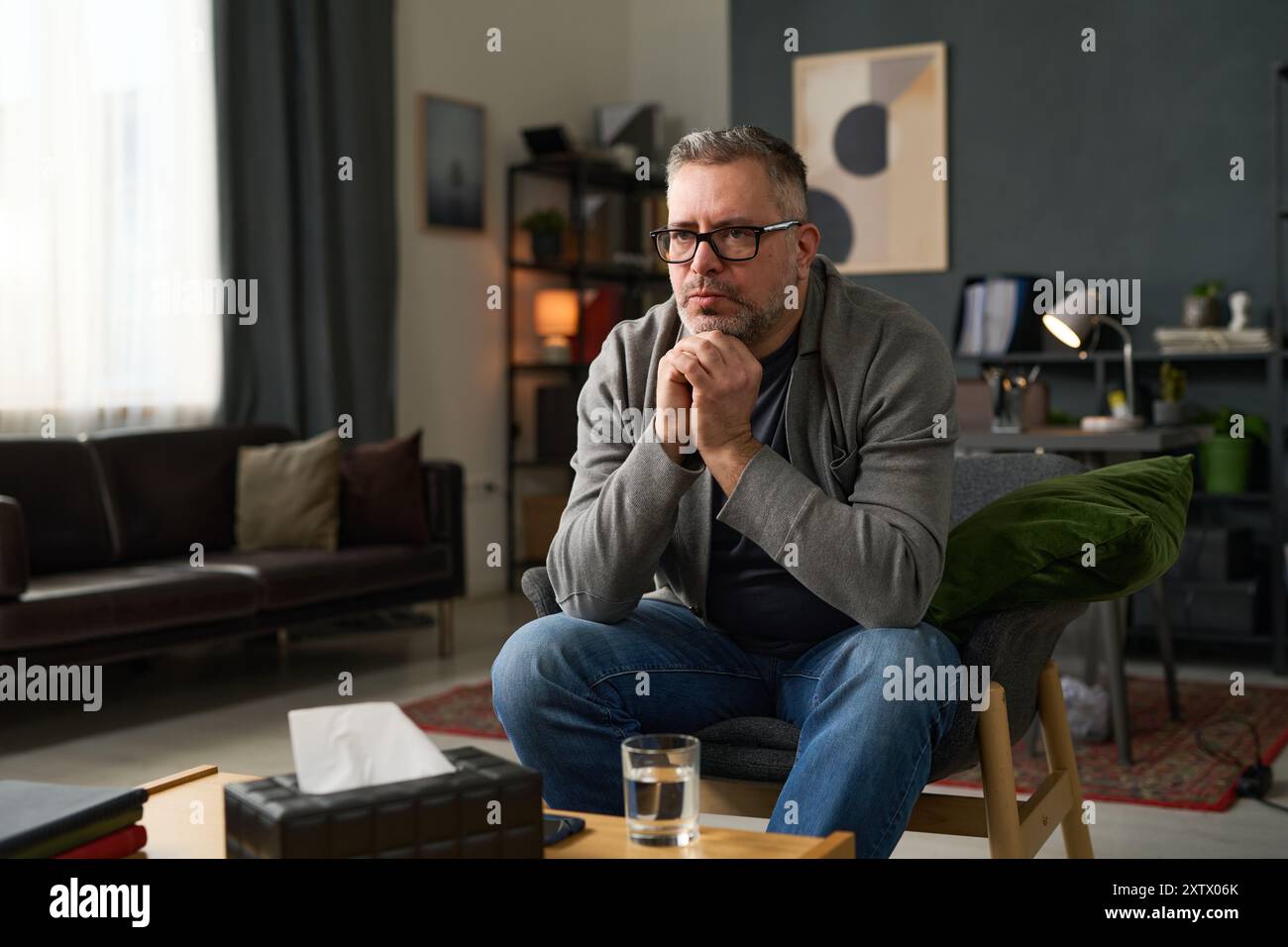 Reflecting in Living Room with Contemplative Expression Stock Photo - Alamy