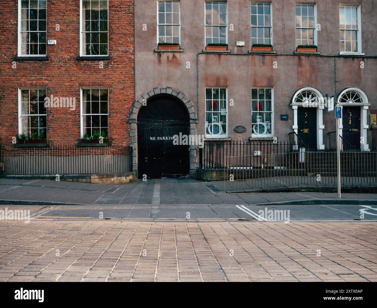 The view showcases a serene urban street lined with historic buildings ...