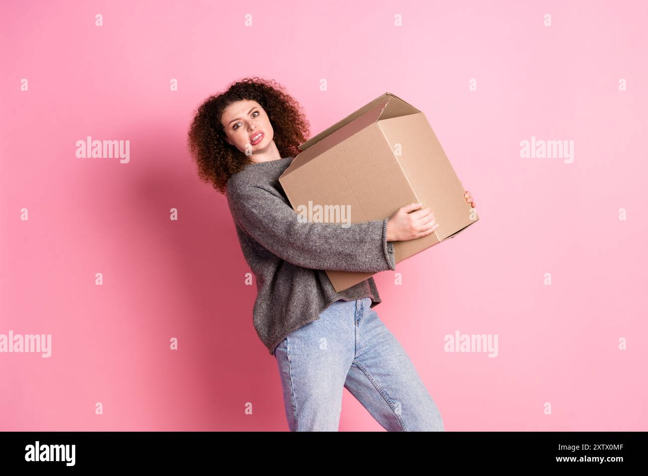 Photo portrait of attractive young woman carry suffer heavy carton box ...