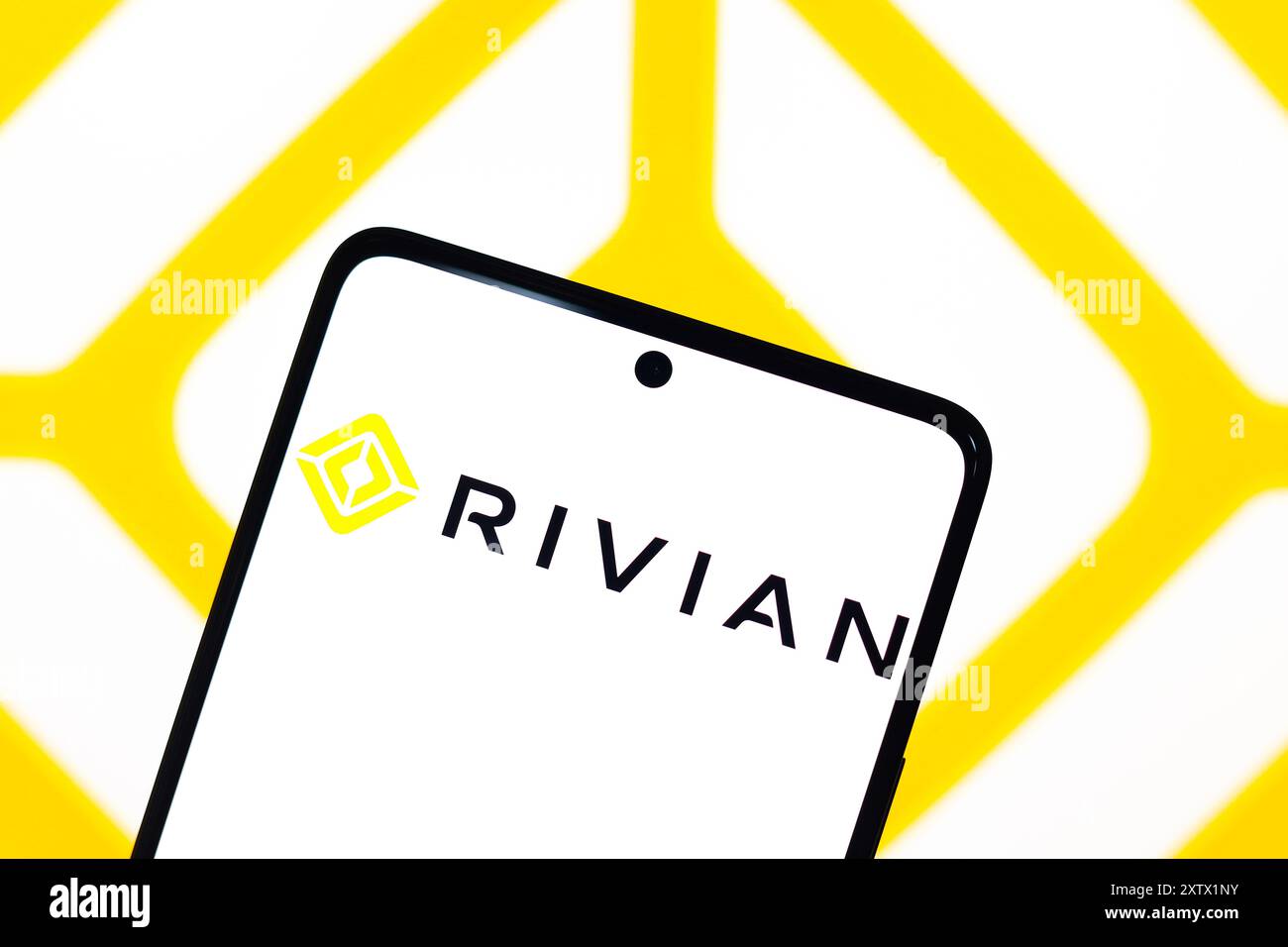 In this photo illustration, the Rivian Automotive, Inc. logo is ...