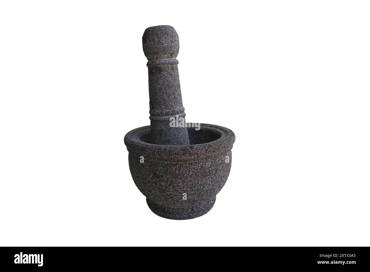 A large mortar and pestle sits on a white background. The mortar is ...