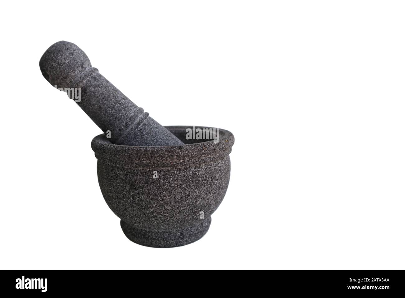 A large mortar and pestle sits on a white background. The mortar is ...