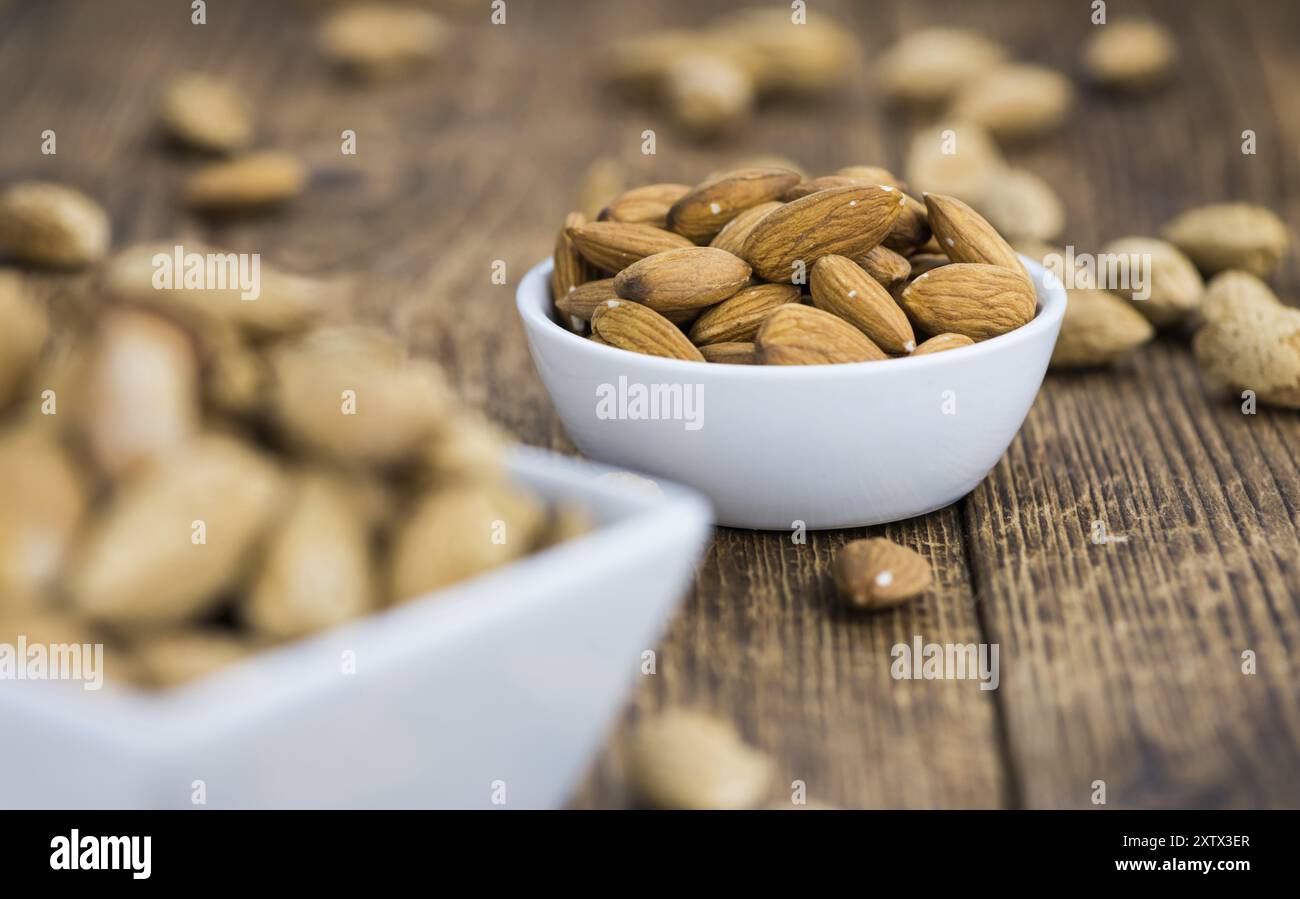 Almonds in shell (roasted and salted) on a vintage background (close-up ...