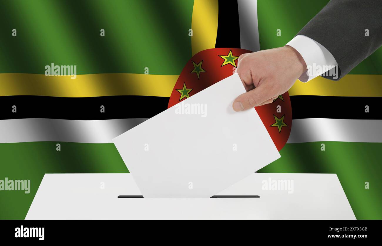 The Dominica flag and the hand with the bulletin about the ballot box ...