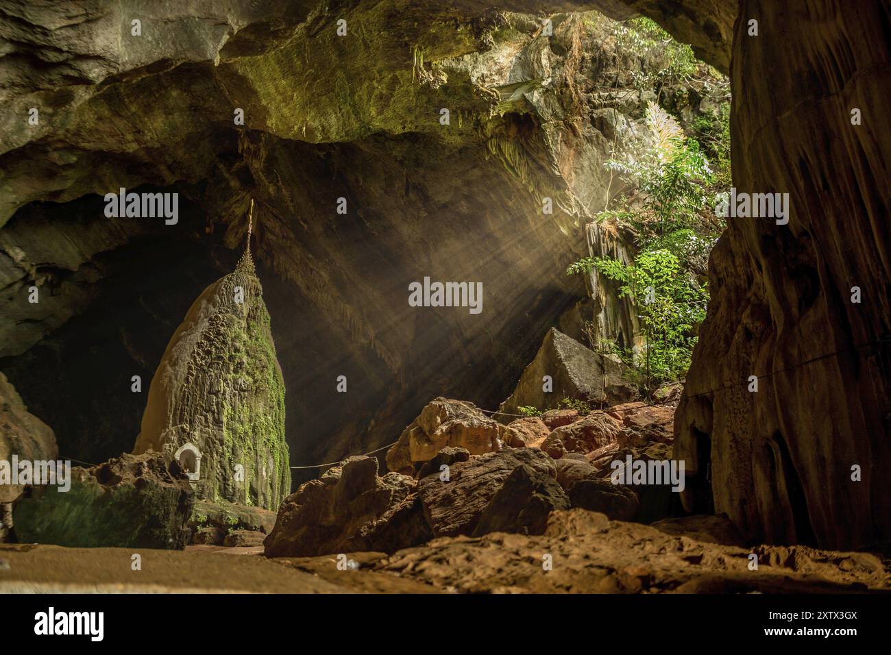 Sunrays illuminating sacred rock in the Kaw Goon cave Stock Photo - Alamy