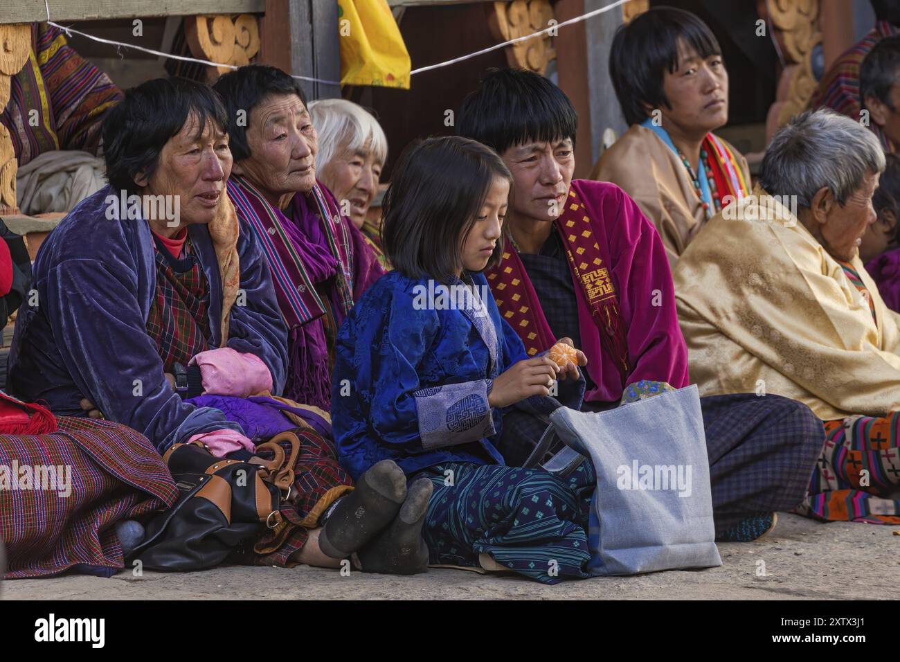 Bhutanese people in traditional clothes watching the annual Tsechu of ...