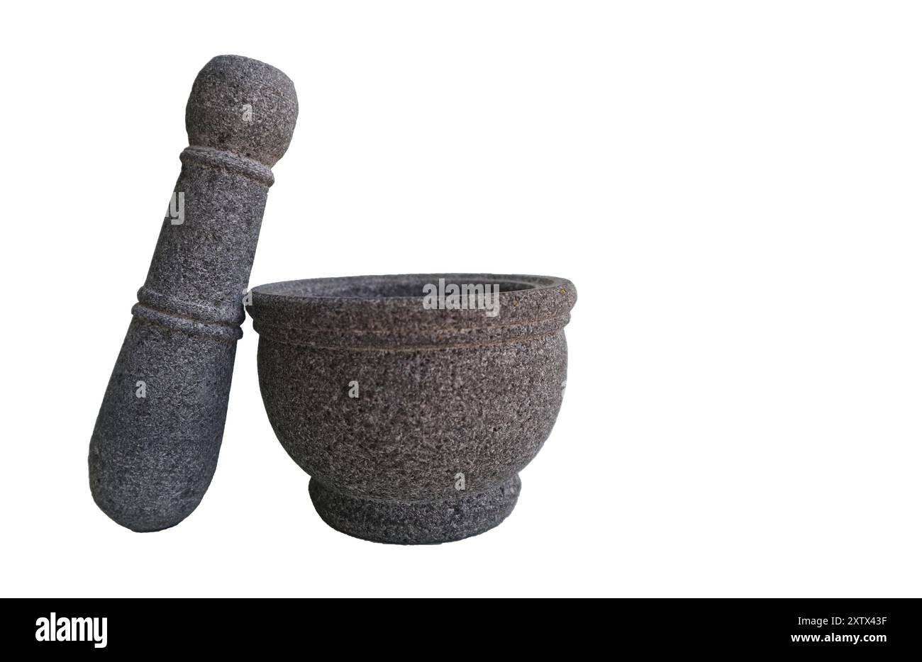A large mortar and pestle sits on a white background. The mortar is ...