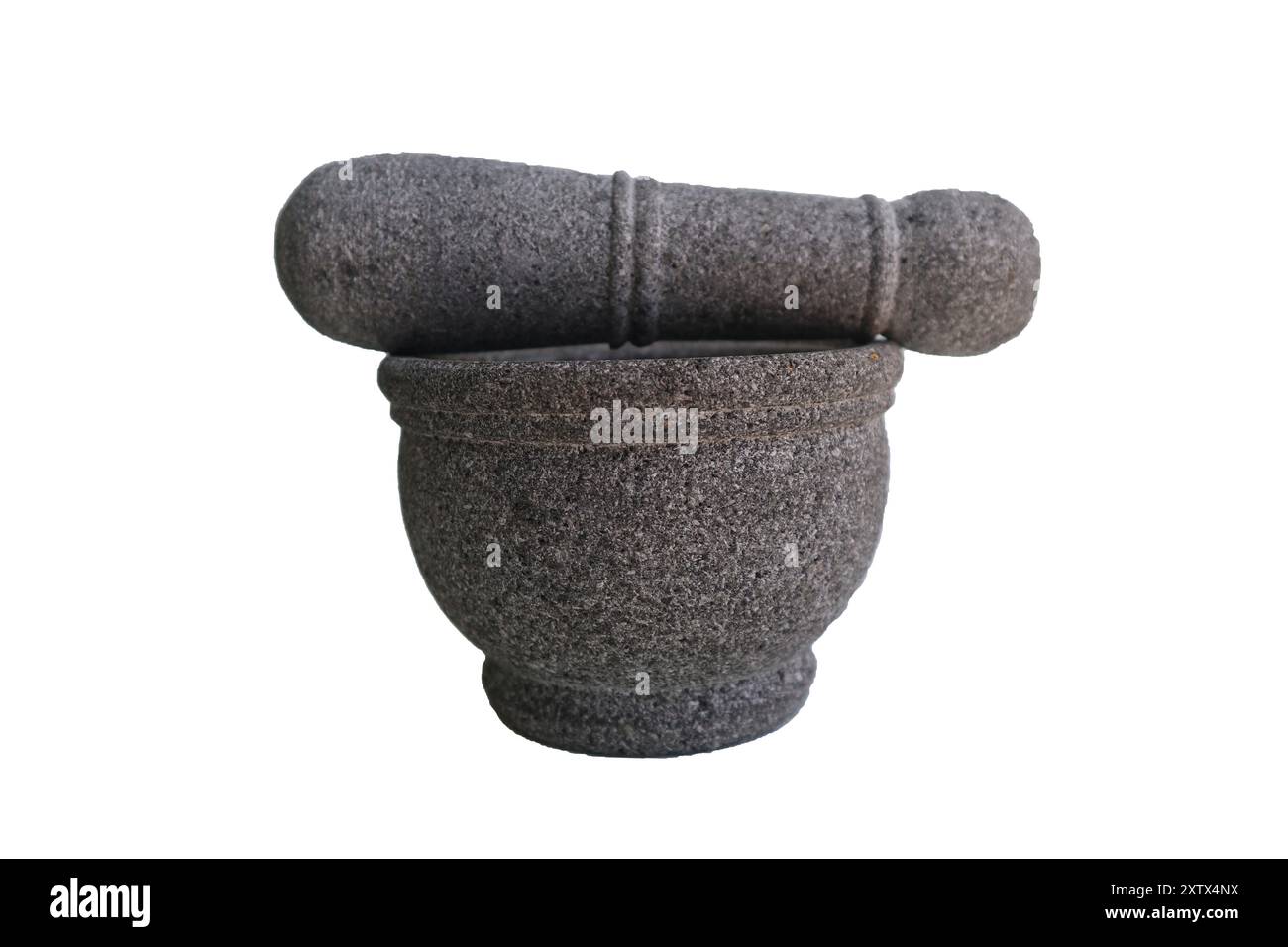 A large mortar and pestle sits on a white background. The mortar is ...