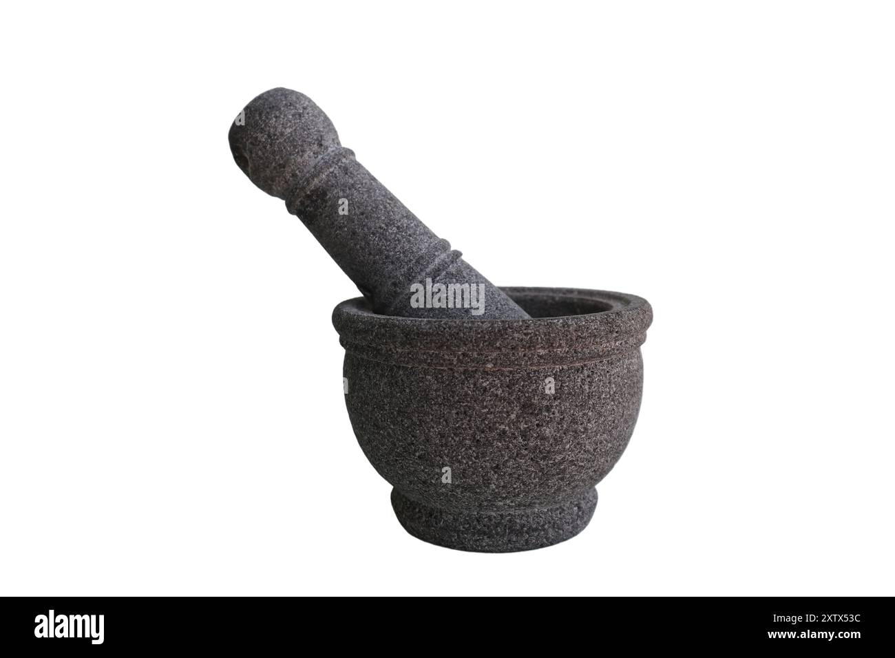 A large mortar and pestle sits on a white background. The mortar is ...